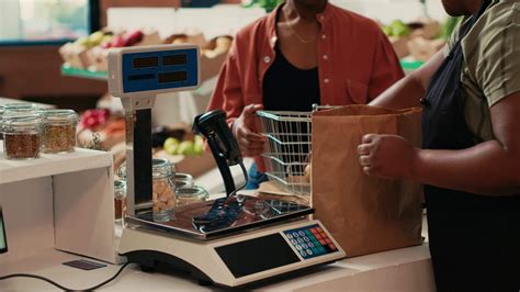 Grocery Store Owner Weighting Fruits And Vegetables On Scale To Sell