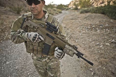 Man In Military Suit Holding Assault Rifle Hd Wallpaper Wallpaper Flare