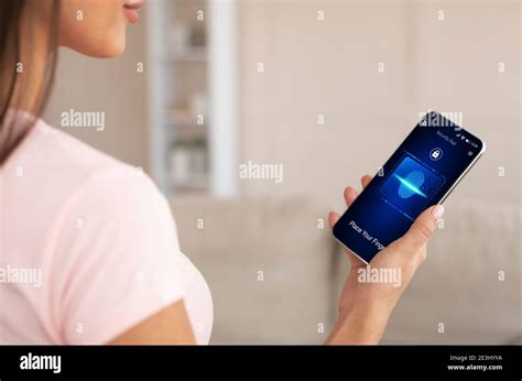 Woman Holding Smartphone With Fingerprint Scanner For Authorization