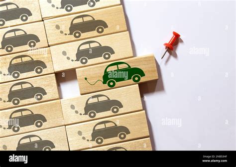 Top View Of Green Electric Car Between Polluting Fossil Combustion