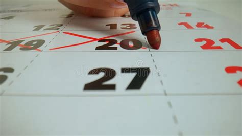 Red Marker Highlighting Crossing Out The Calendar Days Of The Month On The Paper Page Three