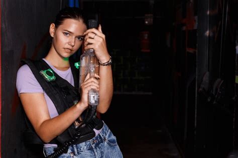 Active Woman With Laser Guns Took Aim And Posing During Laser Tag Game In Labyrinth Royalty