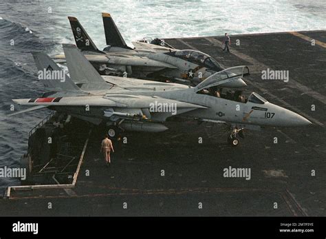 A Right Side View Of Two F 14 Tomcat Fighter Aircraft Parked On The Flight Deck Of The Nuclear