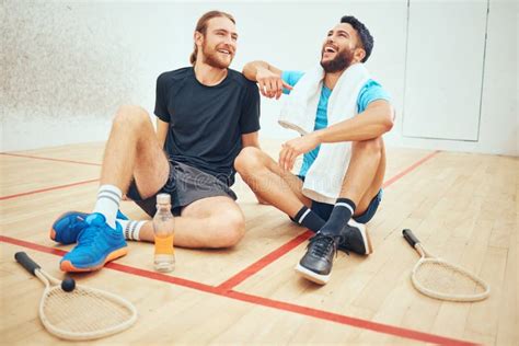 Two Young Athletic Squash Players Taking Break After Playing Court Game