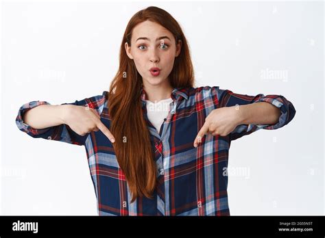 Wow Check It Out Surprised And Curious Ginger Girl Pointing Down