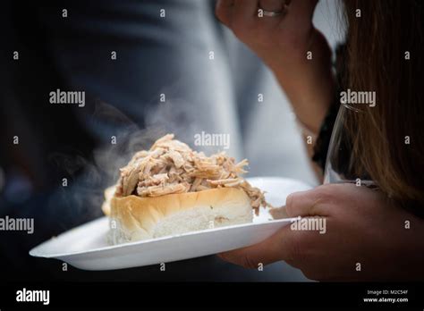 Woman Eating Food From Paper Plate Mid Section Close Up Stock Photo