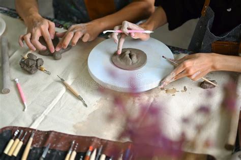 Man Hands Shaping And Scraping Raw Clay On Pottery Wheel Creating