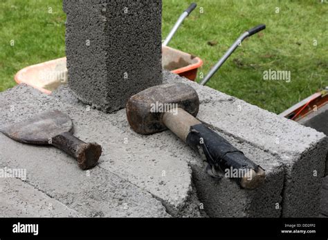 A Lump Hammer And Chisel Rest On A Pile Of Foundation Stones Stock