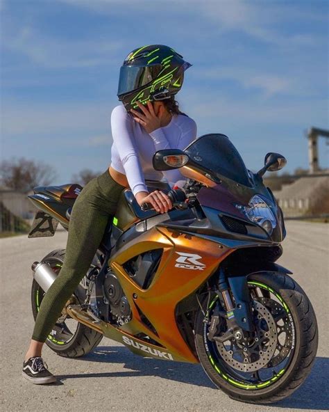 A Woman Sitting On Top Of A Motorcycle
