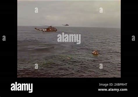 Divers Recover The Unmanned Apollo Command Module After A Splashdown And It Is Brought Aboard