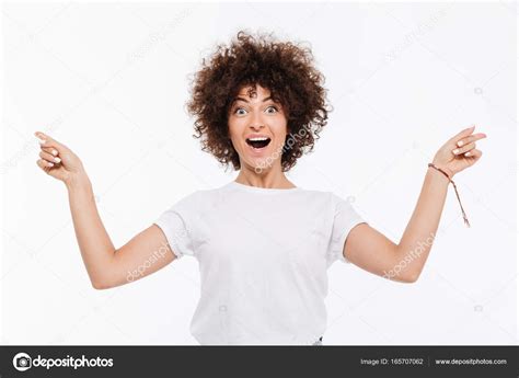 Happy Excited Woman With Curly Hair Pointing Fingers Sideways — Stock