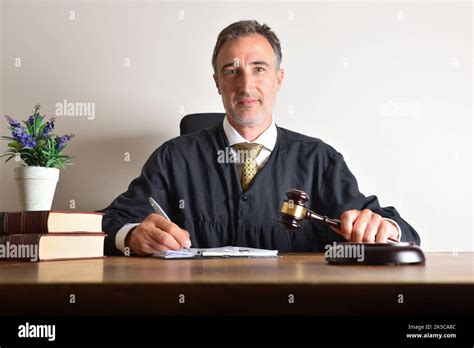 Judge Dressed In The Toga And With The Gavel In His Hand Signing