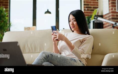 Happy Freelancer Answering Client Email On Smartphone While Working