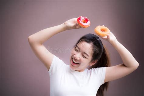 Woman Holding A Donuts Is Doing A Fun Pose People Hold Donuts Over