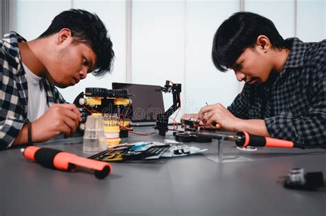 Engineer Asian Students Assembling Robotics Kits Learning Mechanical