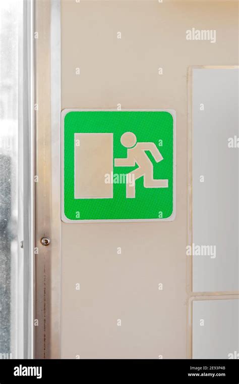 Glow In The Dark Emergency Exit Sign At Wall Stock Photo Alamy