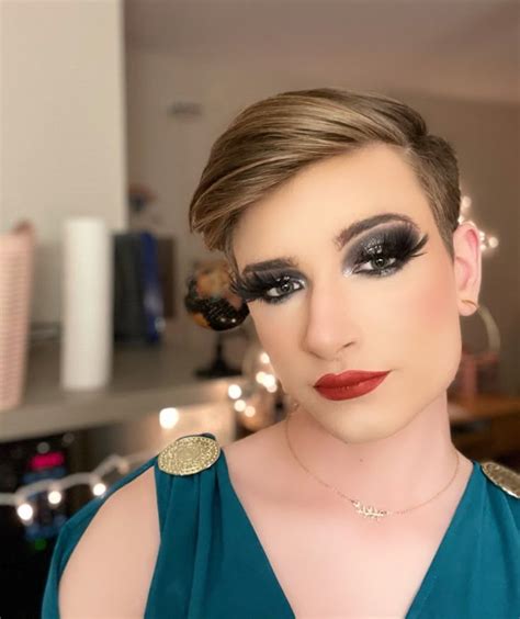 A Woman With Dark Makeup And Gold Accessories On Her Head Is Looking At