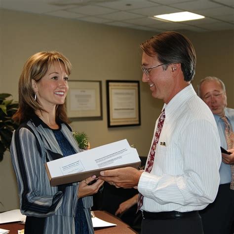 Recognition Program With Employees Receiving Awards Or Certificates For Outstanding Performance