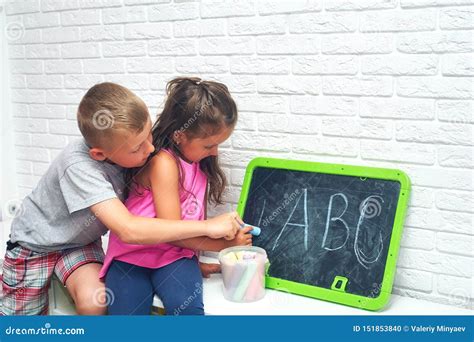 Big Brother Teaches Sister To Write Letters In Summer Holidays Stock