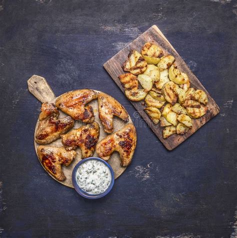 Delicious Grilled Chicken Wings With Garlic Sauce On A Round Cutting