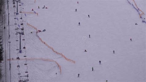 Skiers And Snowboarders Ride On A Snowy Slope At A Ski Resort In Sunny