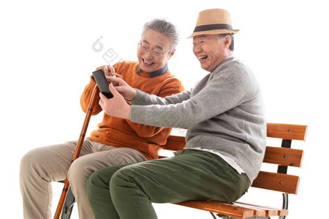 两位老年朋友坐在长椅上看手机相伴高清影相图片 包图网企业站