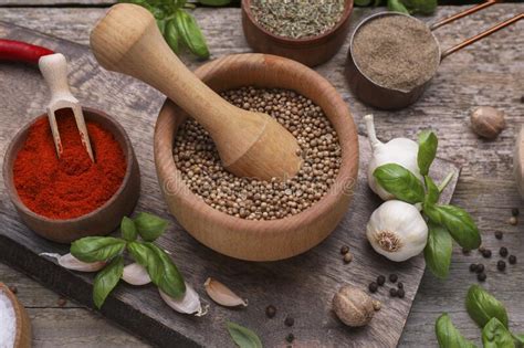 Mortar With Pestle And Different Spices On Wooden Table Above View