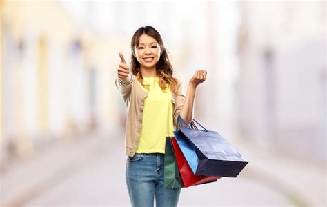 Premium Photo Asian Woman With Shopping Bags Showing Thumbs Up
