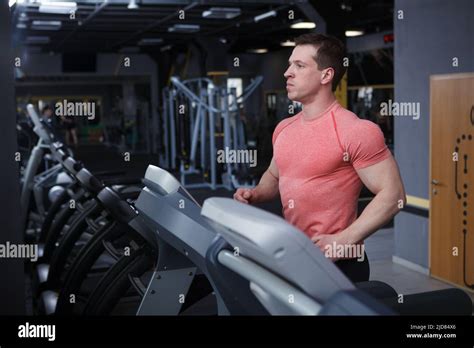 Muscular Man Running On A Treadmill At The Gym Stock Photo Alamy