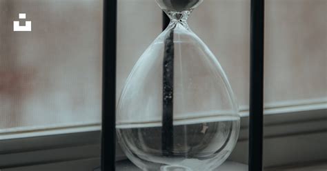 Clear Hour Glass On Table Photo Free Grey Image On Unsplash