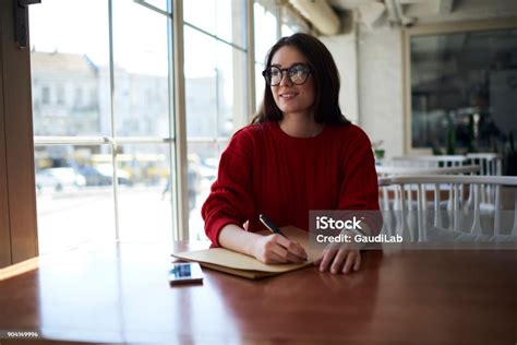 실내에 앉아 자유 시간을 즐기는 젊은 웃는 Hipster 소녀 메모장에 코스 프로젝트 쓰기 일반 개념에 대 한 아이디어에 대해