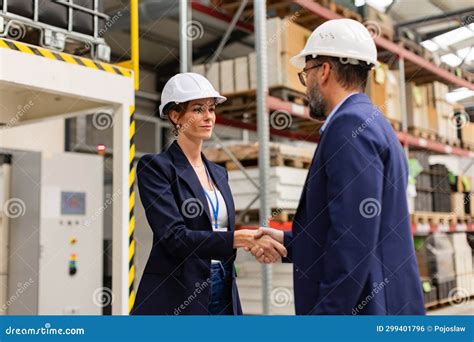 Female Engineer And Male Project Manager Shaking Hands In Modern