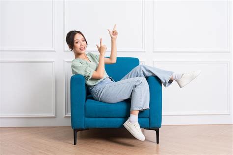 Premium Photo Image Of Young Asian Girl Sitting On Sofa At Home