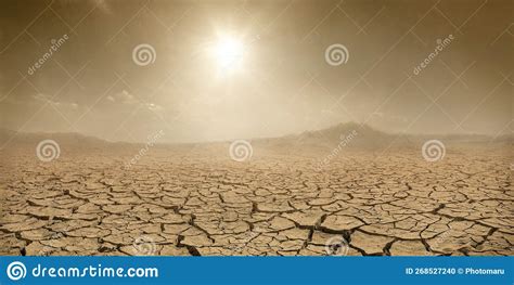 Barren Terrain Panorama Sun Shining Over Cracked Dried Land And Clouds