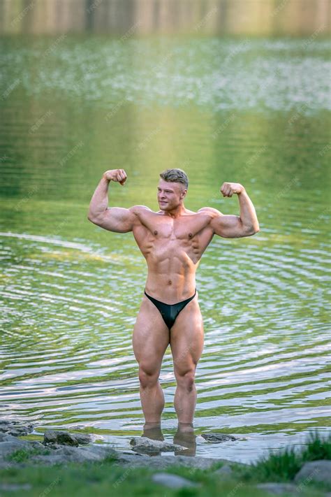 Premium Photo Male Bodybuilder In The Water In Nature