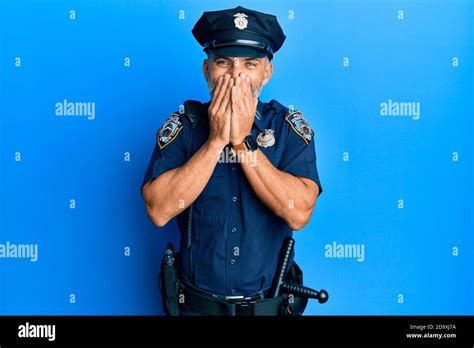 Middle Age Handsome Man Wearing Police Uniform Laughing And Embarrassed