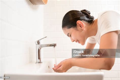 Wanita Cantik Asia Sedang Mencuci Muka Di Kamar Mandi Di Rumah Foto