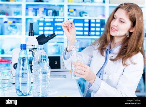 Woman Science Assistant In Laboratory With Test Of Drink Water Stock
