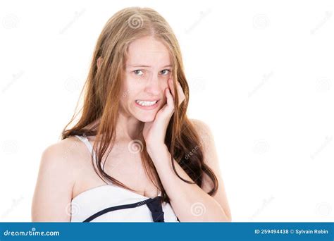 Scared Upset Woman Clenches Teeth Hand On Cheek On White Background