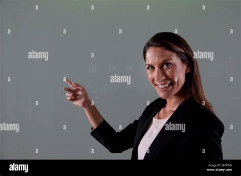 Woman Giving Presentation Pointing At Screen And Smiling Stock Photo Alamy