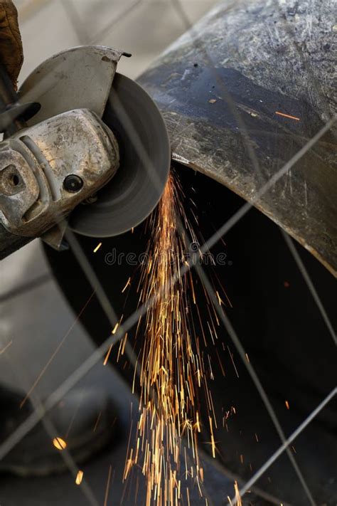 Shallow Depth Of Field Selective Focus Details With A Worker Using An Angle Grinder On An