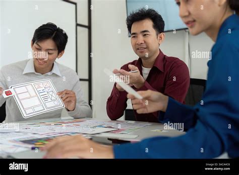 Collaboration And Ux Ui Design A Diverse Group Of Professionals Brainstorms Ux Ui Concepts In A