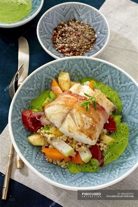 Cod Wrapped In Bacon On Bed Of Vegetables And Couscous With Green Sauce — Shallow Depth Fresh