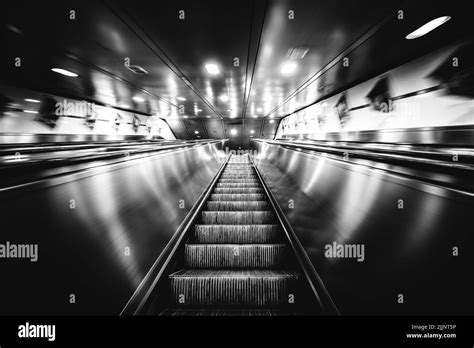 A Photo In Grayscale Of Subway Escalators Stock Photo Alamy
