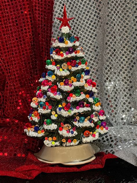 Snow Capped Christmas Tree With Multicolor Globes And Plastic Star