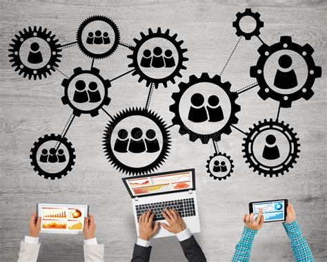 Top View Of Businesspeople Sitting At Table And Using Gadgets Stock