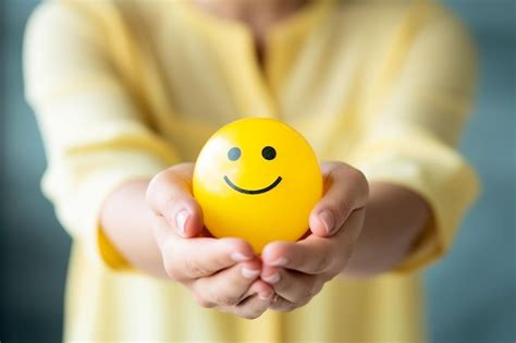 Premium Ai Image Woman Hand Holding Happy Smile Emoji Sphere Position