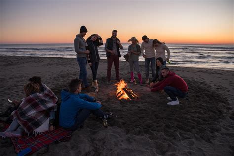 Friends Having Fun At Beach On Autumn Day Stock Photo At Vecteezy