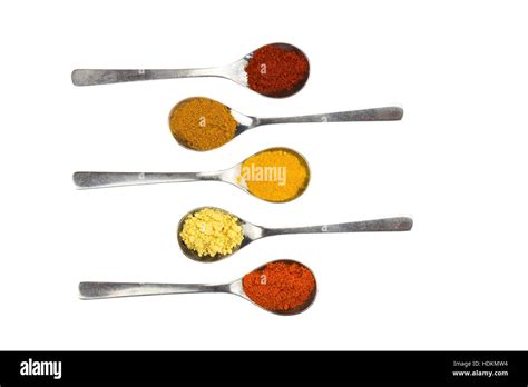 Various Seasoning Spices On Metal Spoons Isolated On White Background
