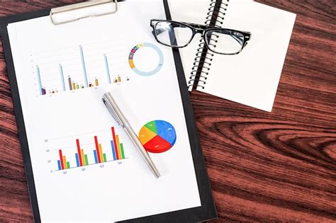 Premium Photo Top View Of Statistical Reports With Glasses And Notebook Wooden Table
